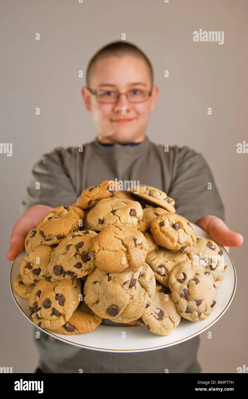 A Boy Holding A Plate Of Chocolate Chip Cookies Stock Photo - Alamy