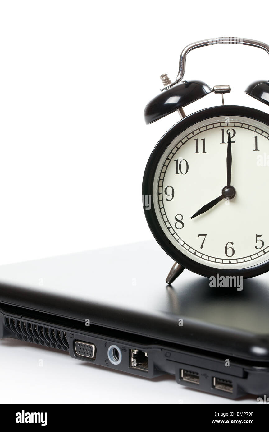 alarm clock and laptop on white background Stock Photo - Alamy