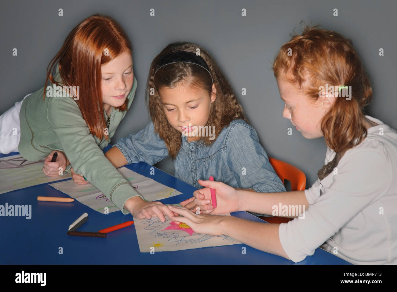 Edmonton, Alberta, Canada; Three Girls Coloring Pictures At A Table ...