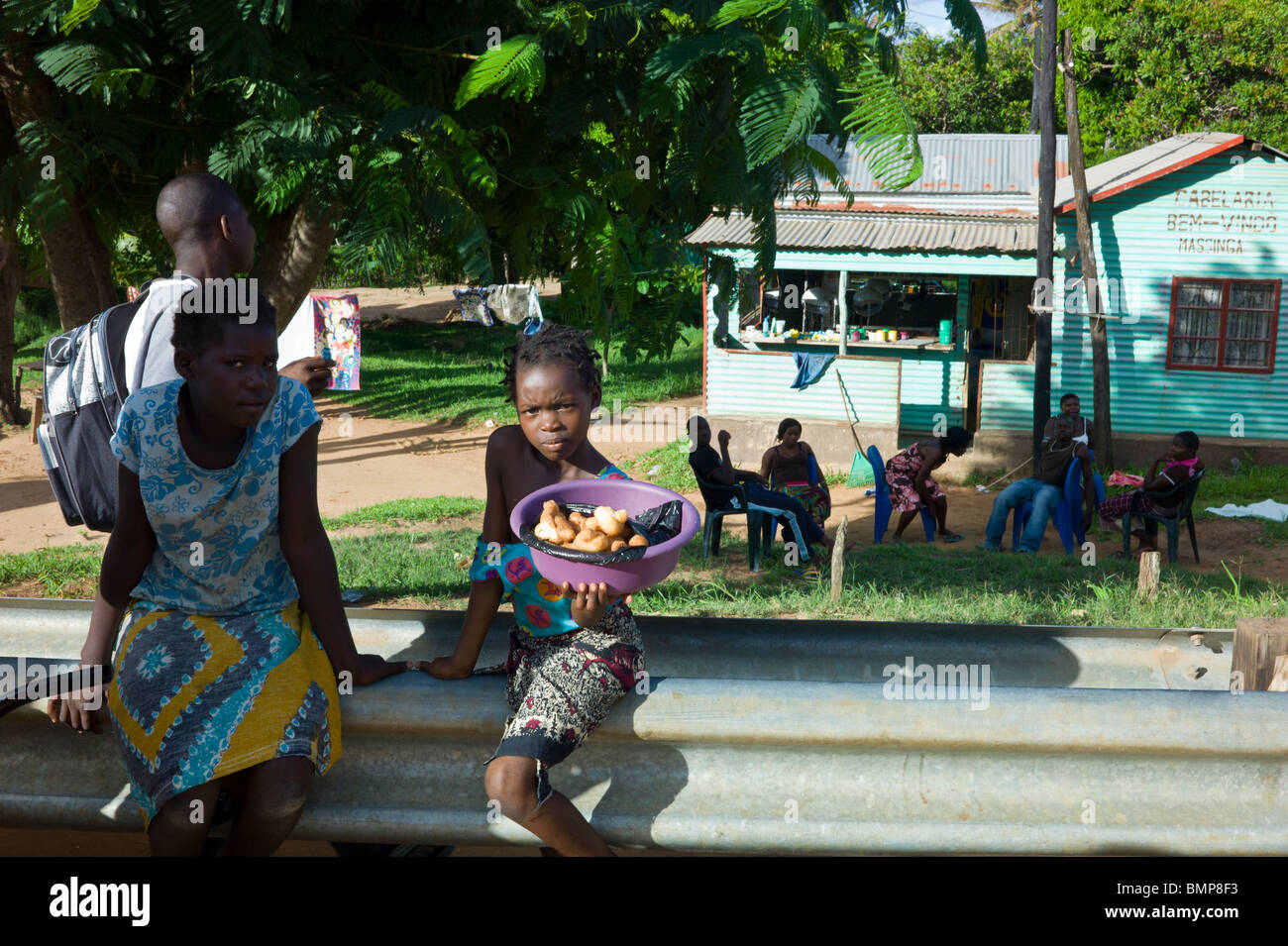 A mother and her child selling fruit in a small roadside town in ...