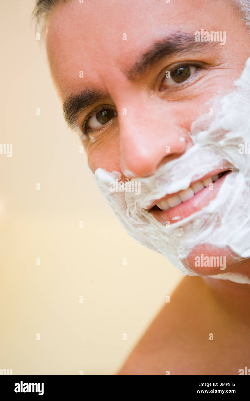 Man with shaving cream on face, smiling, portrait Stock Photo - Alamy