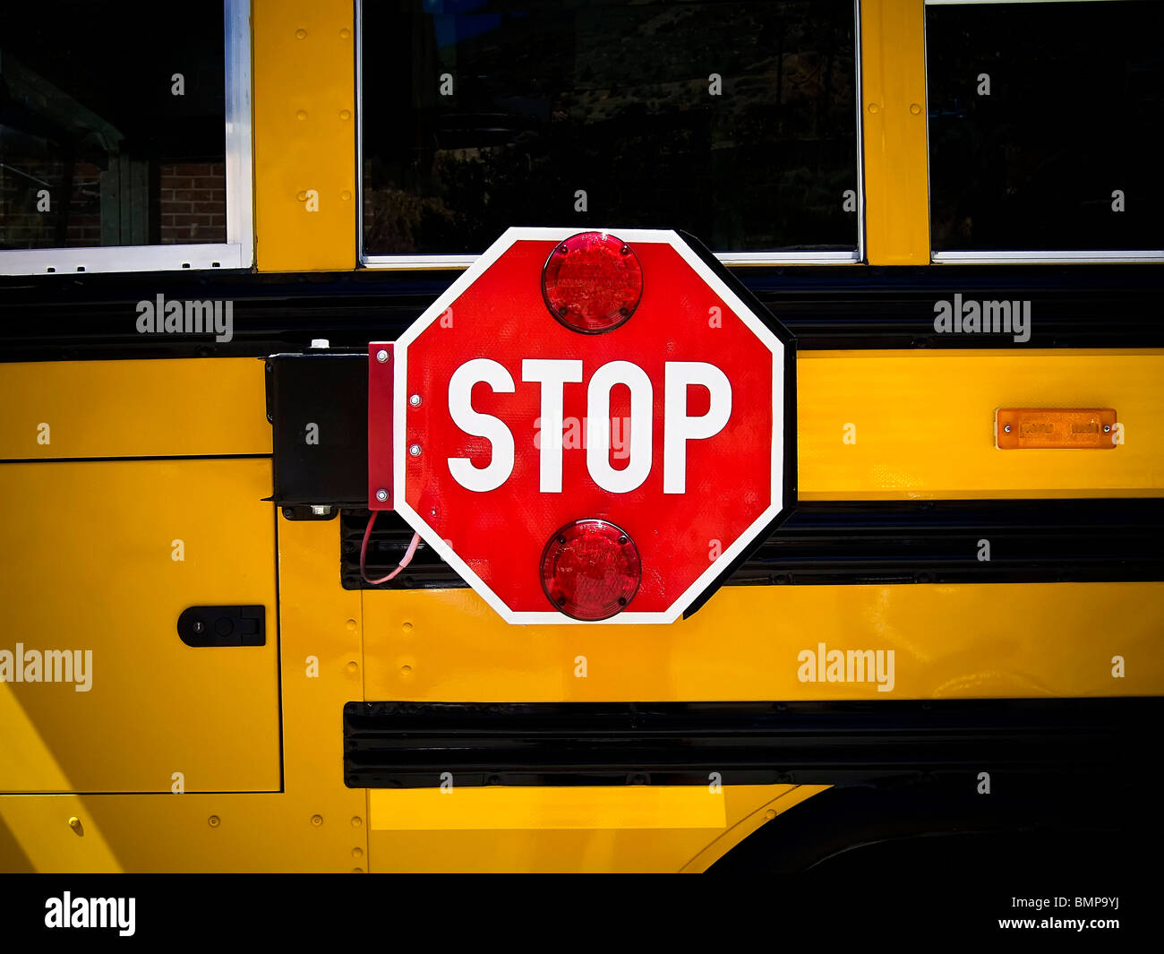 Stop sign on the side of a school bus Stock Photo - Alamy