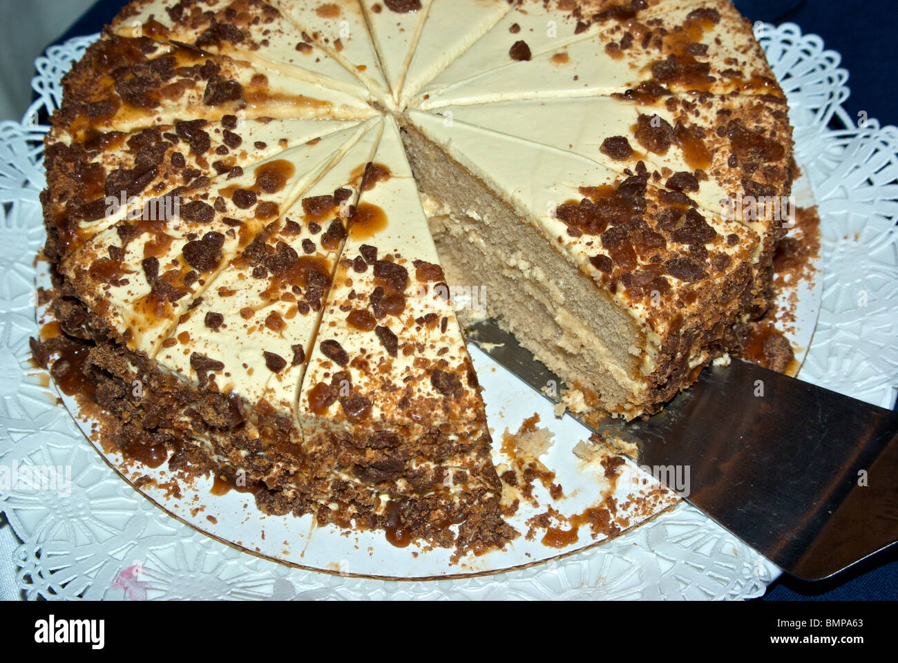 Slice of coffee layer cake broken crushed praline toffee icing Stock ...
