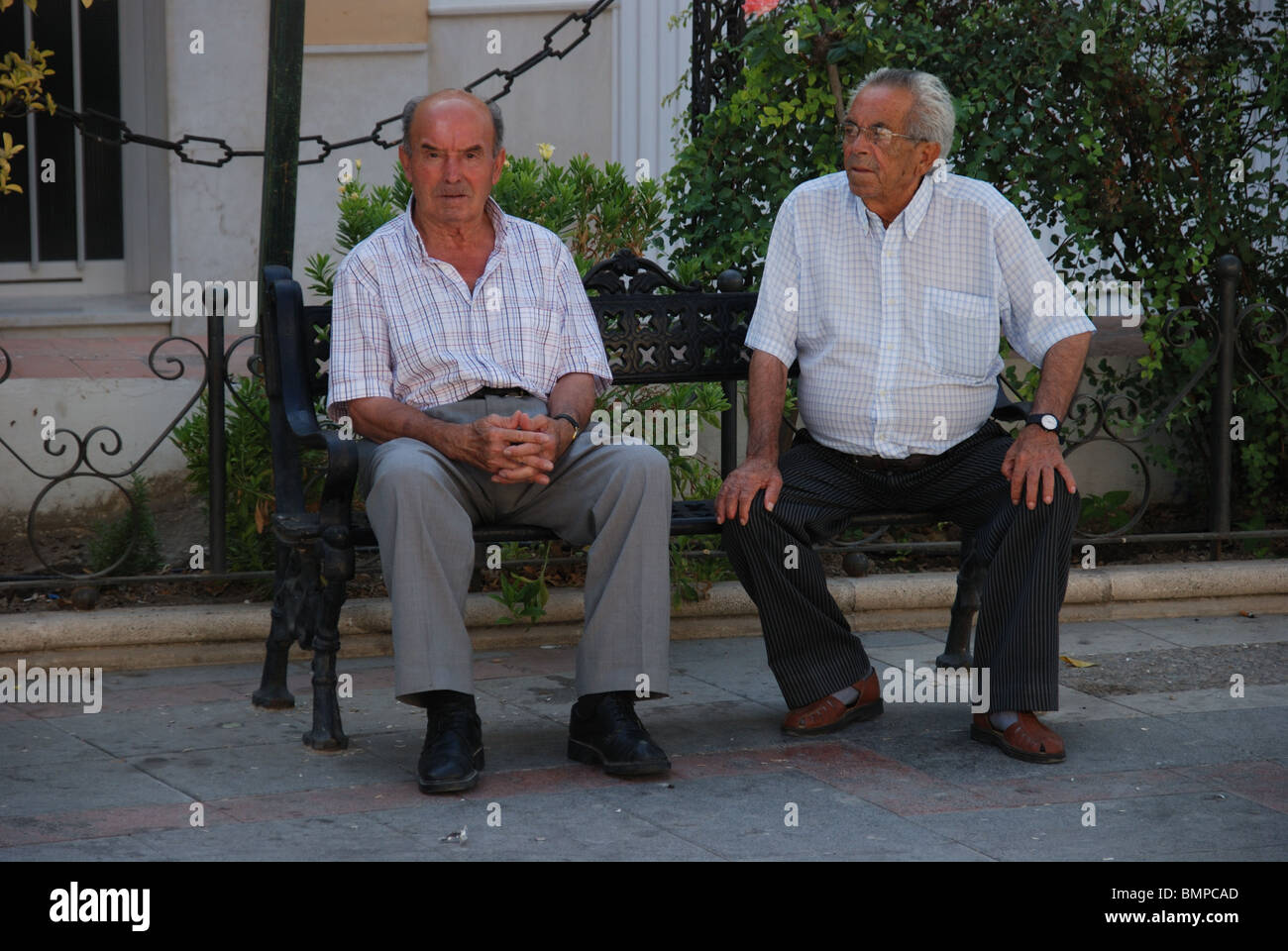 Two elderly Spanish men sitting on a bench, Aguilar de la Frontera ...