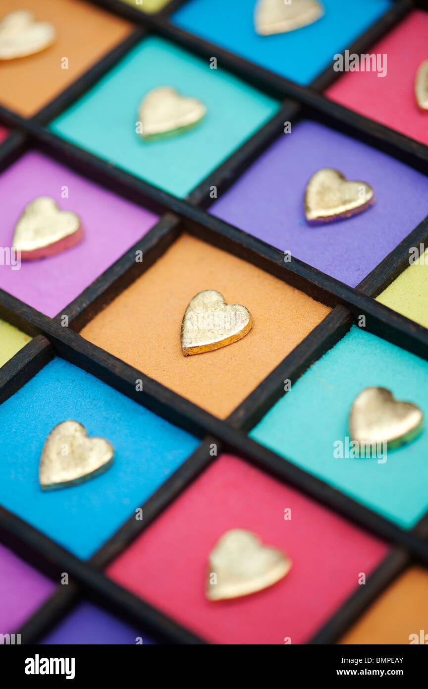 Multicoloured gold heart shape grid pattern in a wooden tray Stock ...
