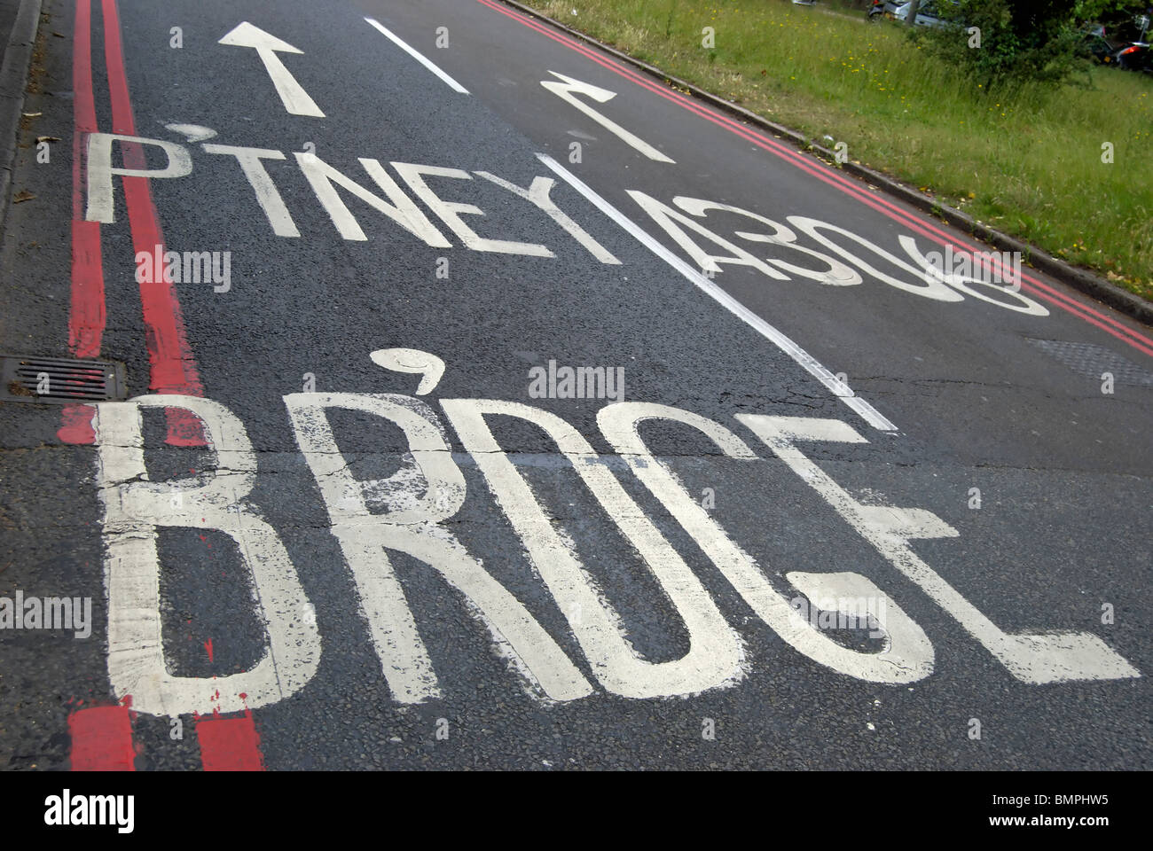 road marking indicating a route to putney bridge, southwest london ...