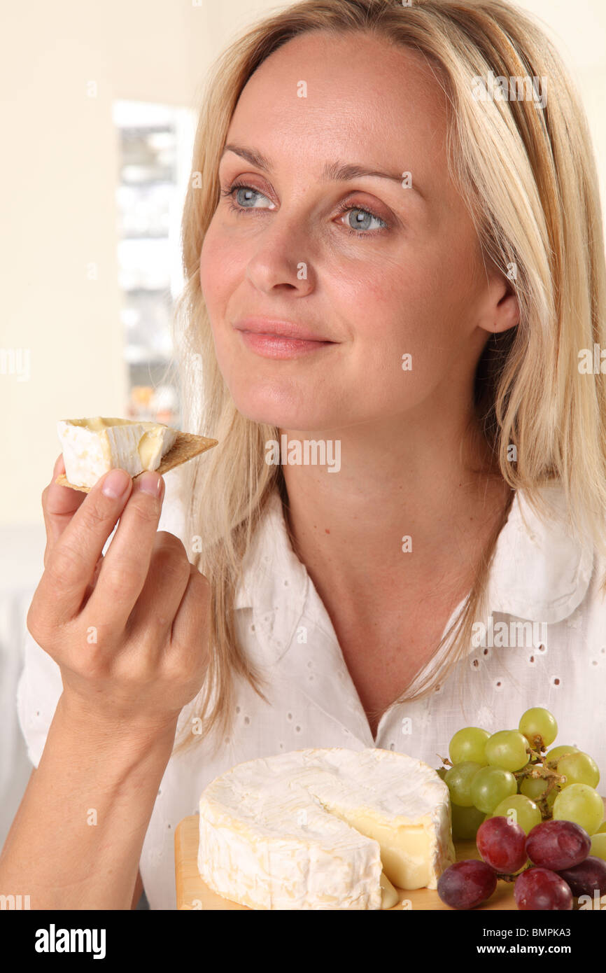 WOMAN EATING CHEESE Stock Photo - Alamy