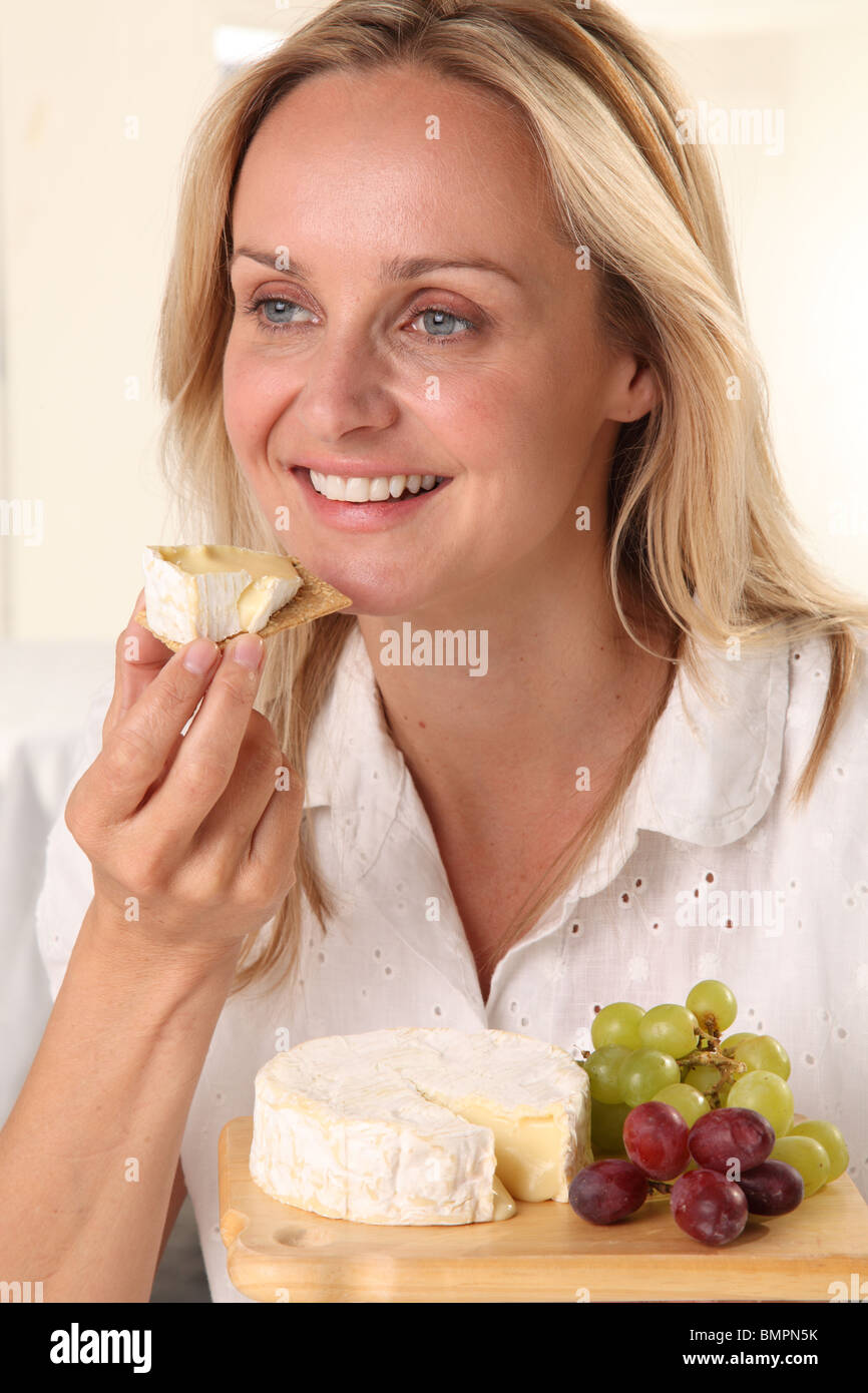 WOMAN EATING CHEESE Stock Photo - Alamy