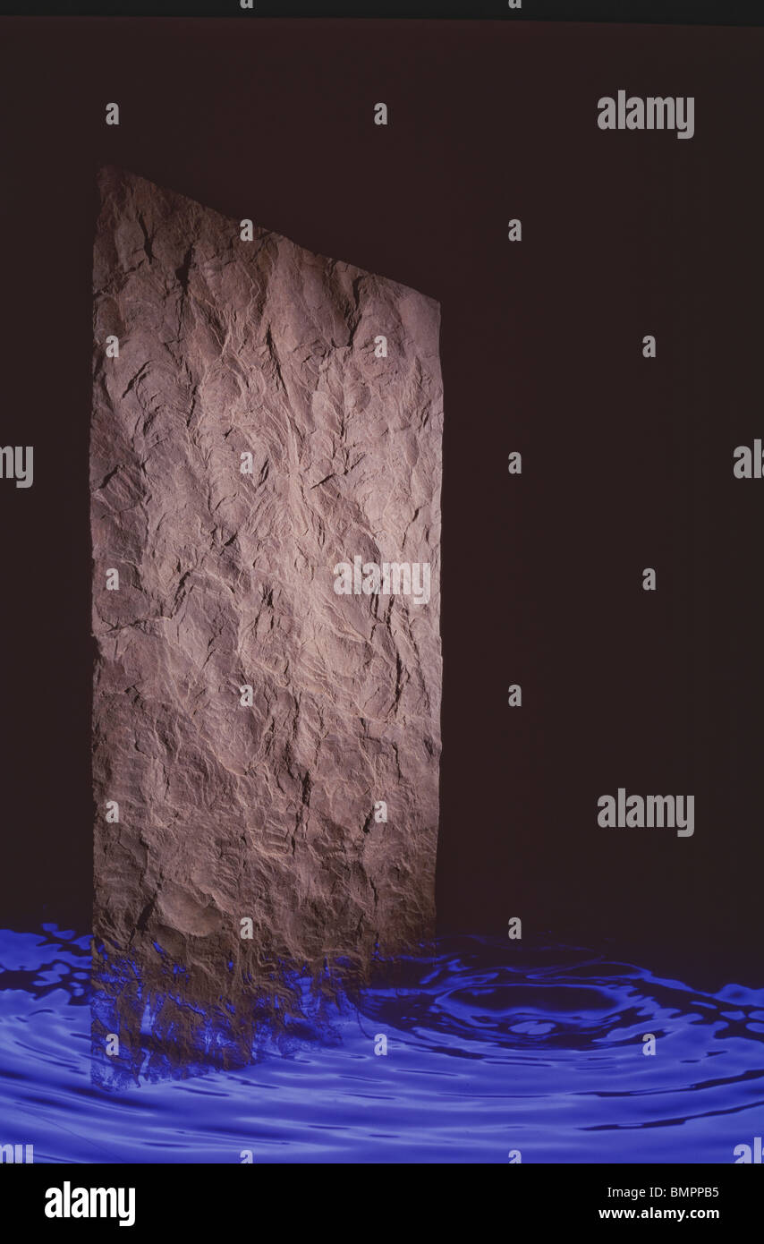 Slab rock rises out of water Stock Photo - Alamy