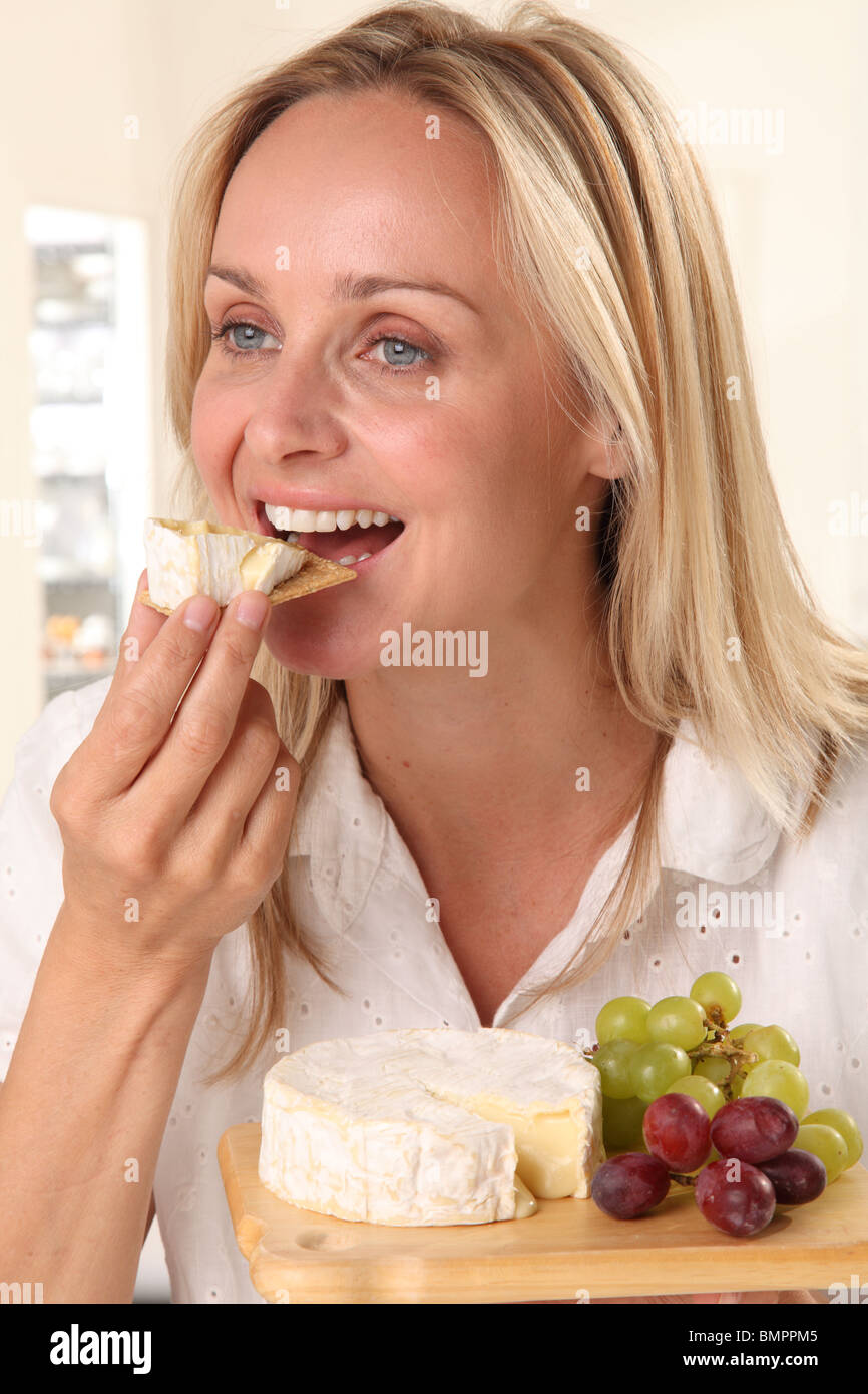 WOMAN EATING CHEESE Stock Photo - Alamy