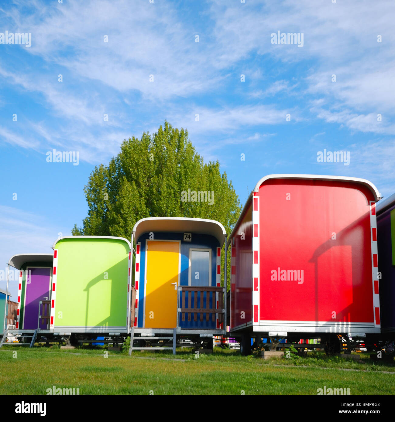 Different color camping trailers against bright blue sky near Amsterdam ...