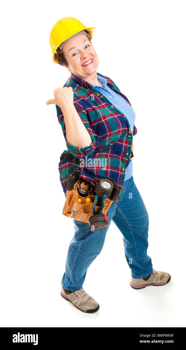 Female construction worker pointing at blank white space behind her ...