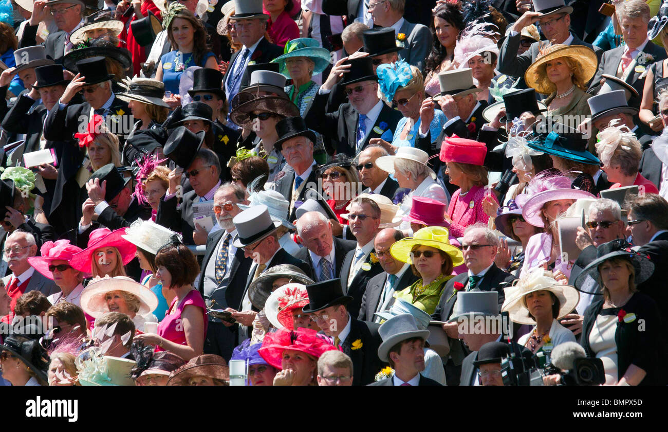 A crowd of race goers wearing hats at the Royal Ascot race meeting in ...