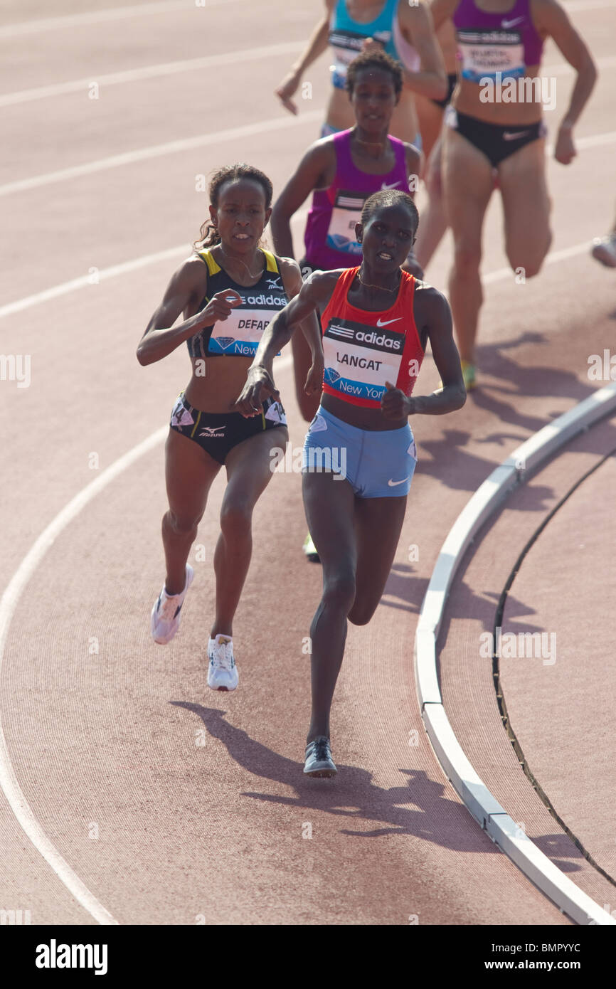 Nancy Jebet Langat (KEN) and Meseret Defar(ETH) lead the competitors in the Women's 1500 meters ...