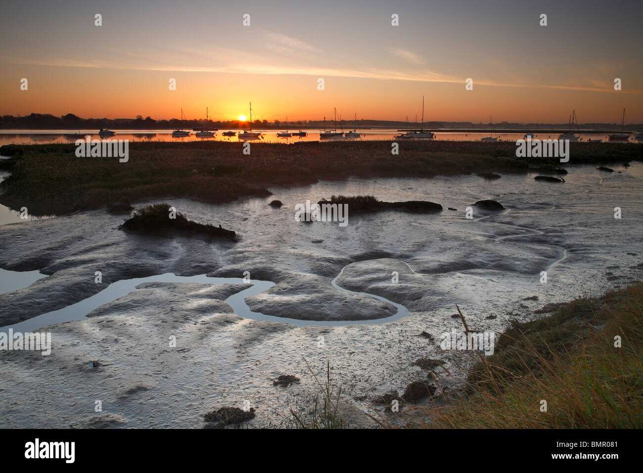 Sunrise over the mud Stock Photo - Alamy