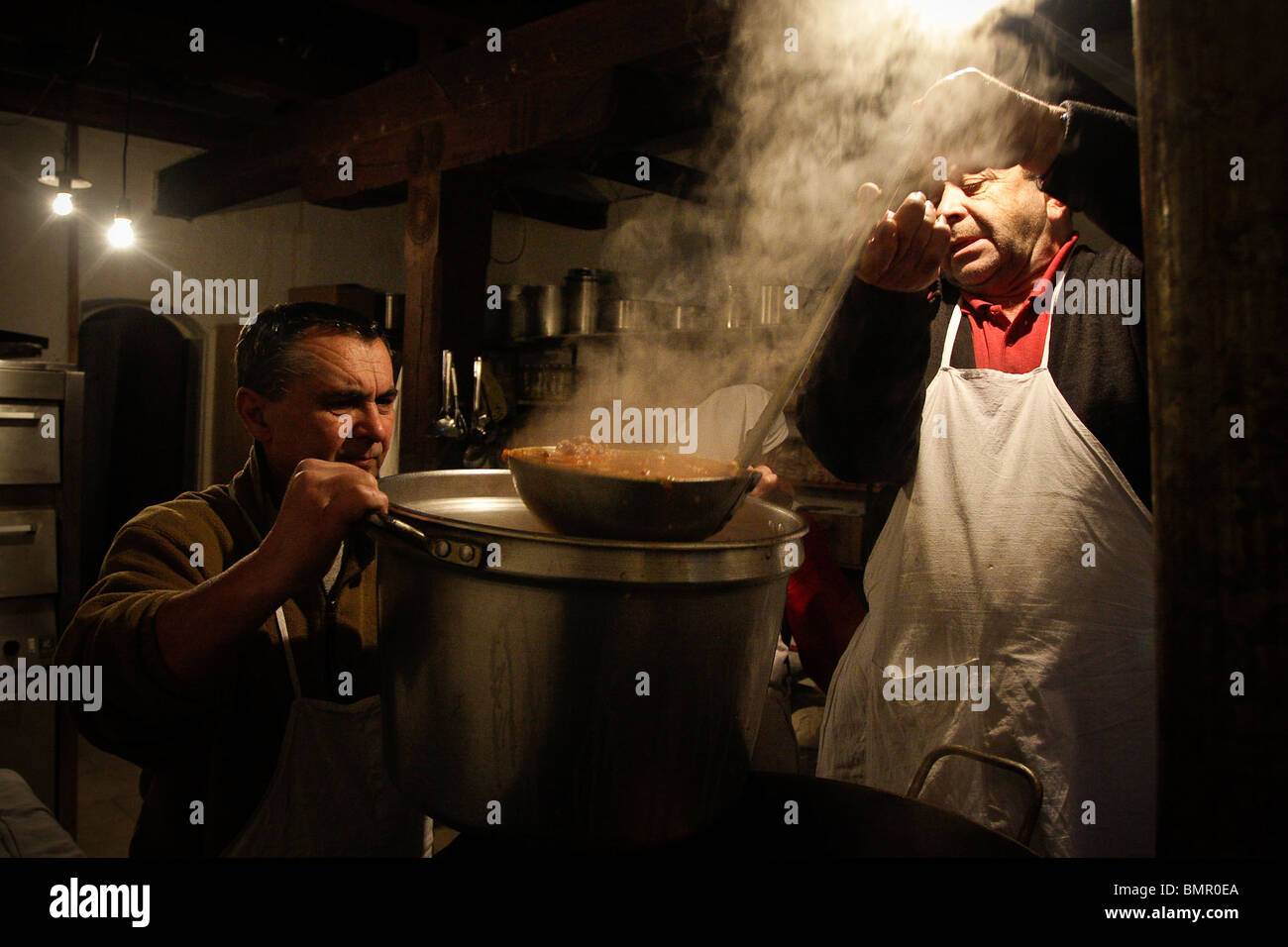 Cookers at public kitchen in Sarajevo preparing meal for poor people ...