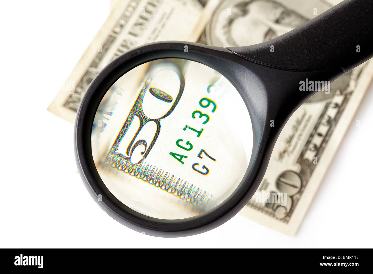 magnifier and money on white background Stock Photo - Alamy