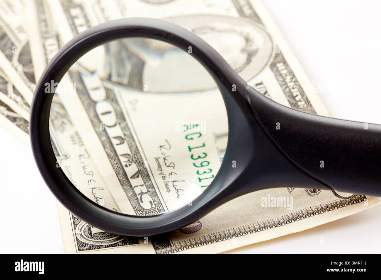 magnifier and money on white background Stock Photo - Alamy