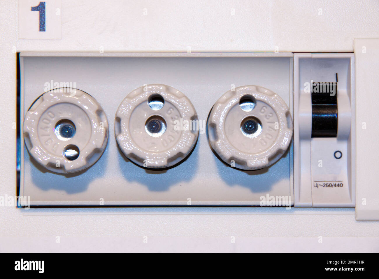 Three fuses lined up and a single switch Stock Photo - Alamy