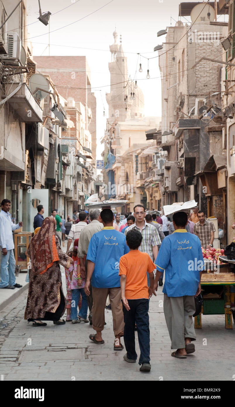 Street scene, Cairo; a crowd in the road in the Khan el Khalili market ...