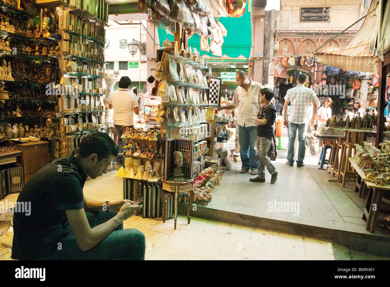 Cairo shopping; Western tourists shopping with local people in a shop ...