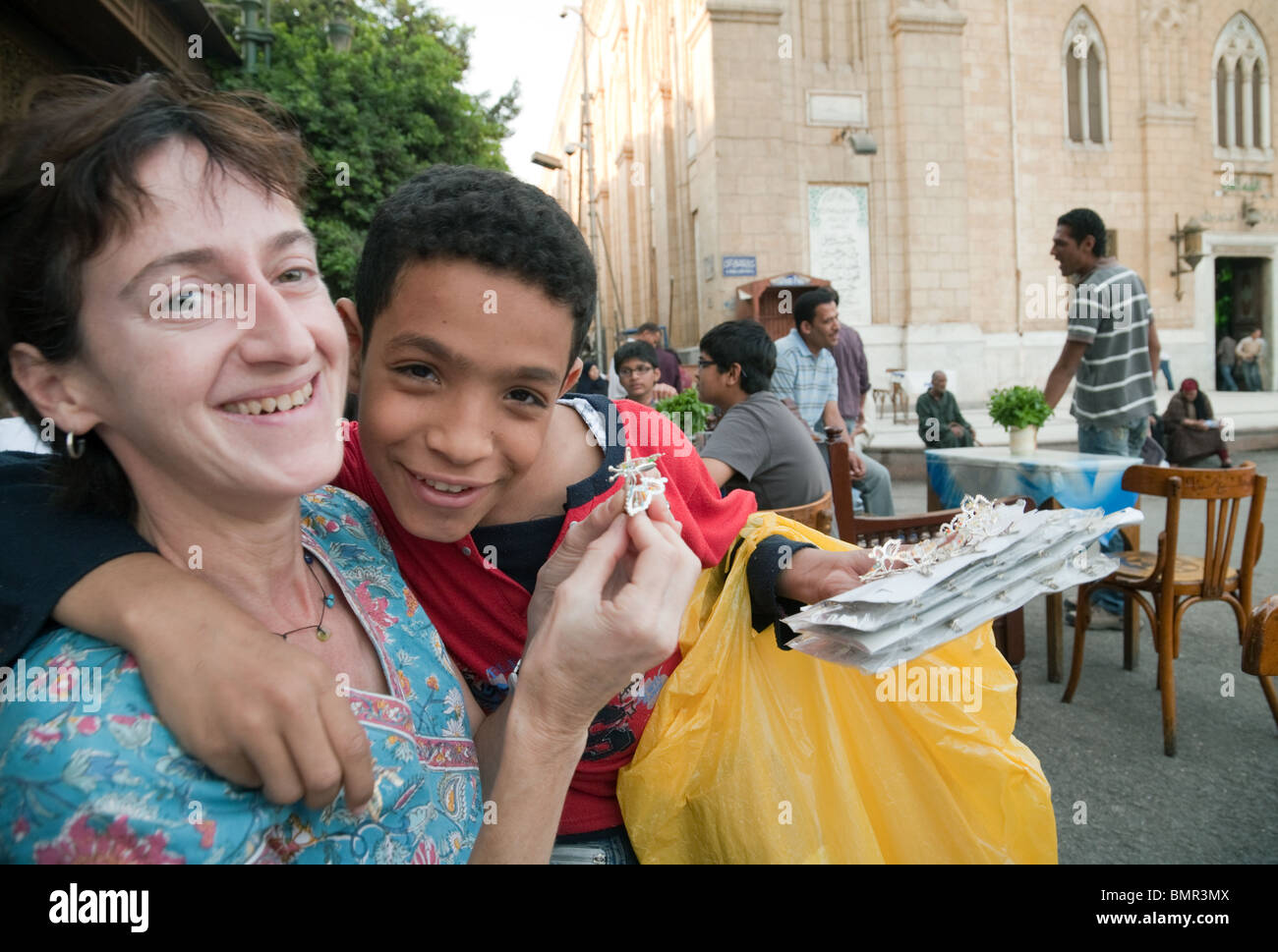 A young egyptian boy making friends with a western tourist to try and ...