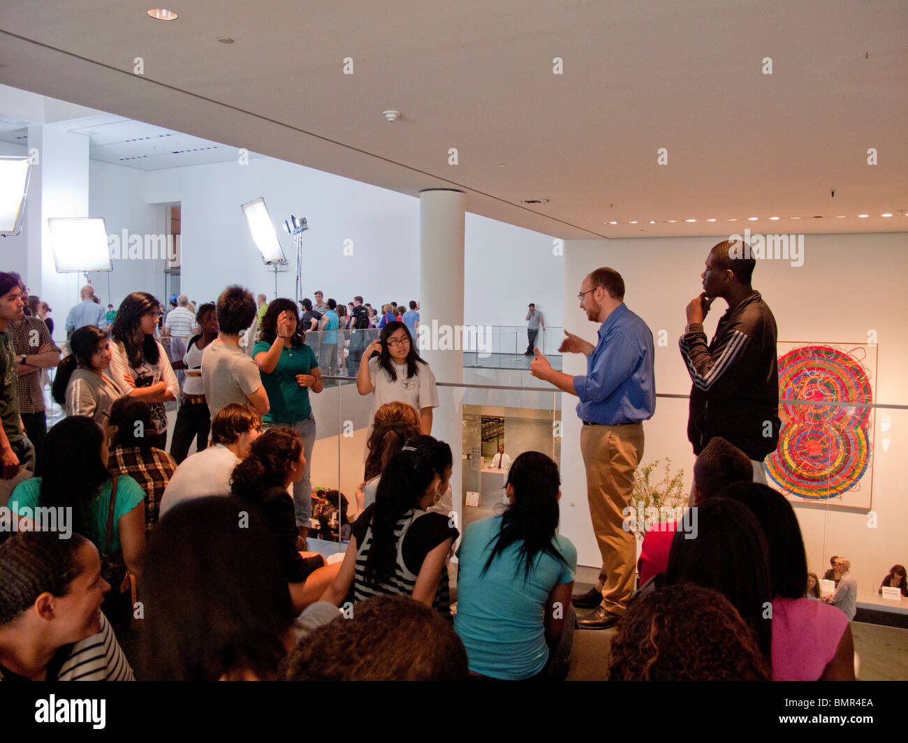Explaining exhibits, a guide (blue shirt) takes visitors through the ...