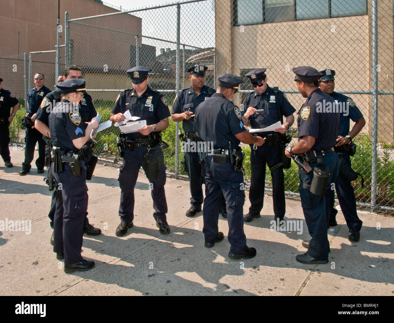 Police officers receive assignments at the beginning of their shift in ...