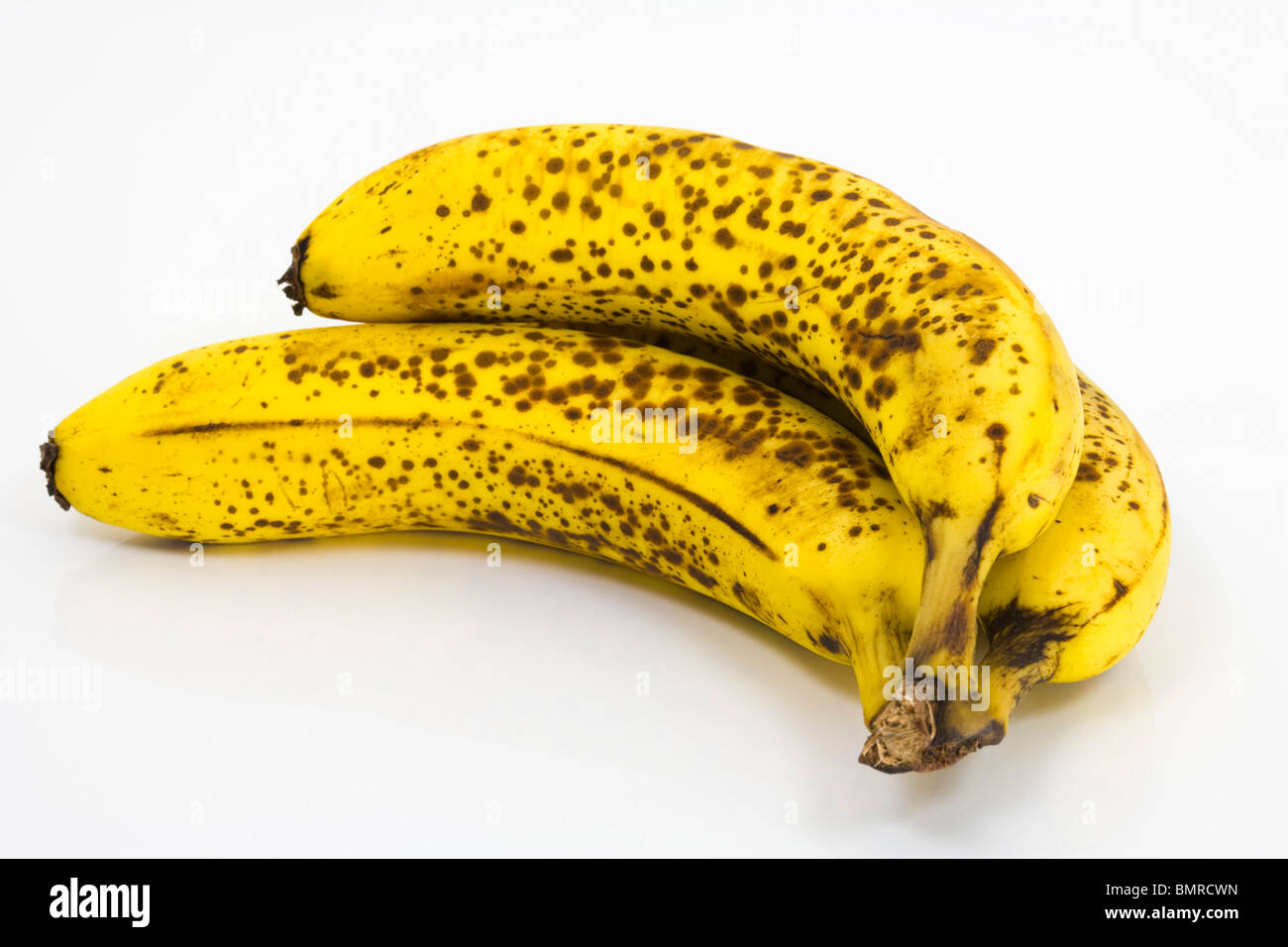 Three spotty bananas on white background Stock Photo - Alamy