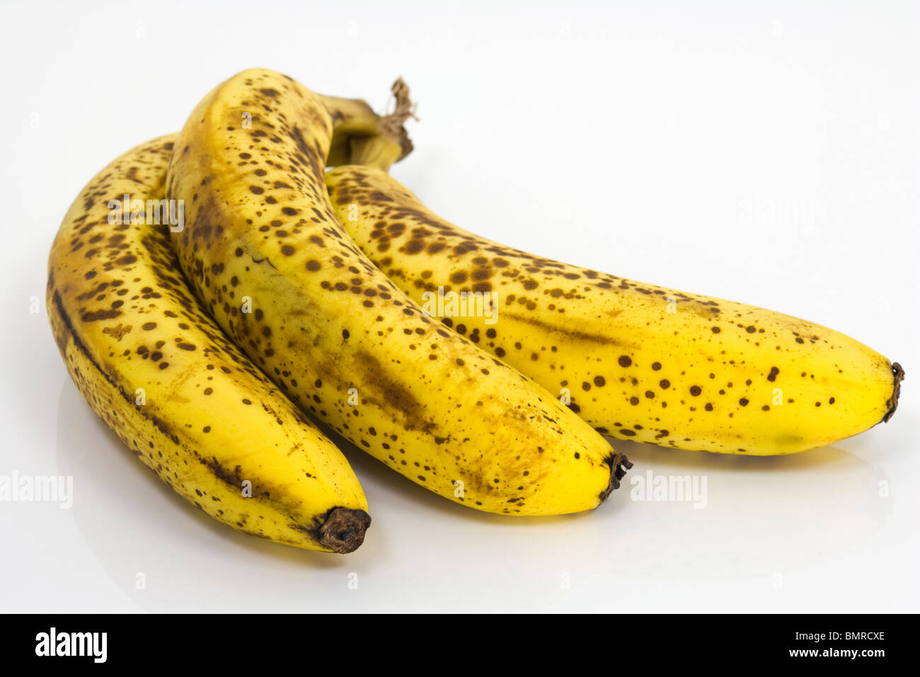 Three spotty bananas on white background Stock Photo - Alamy
