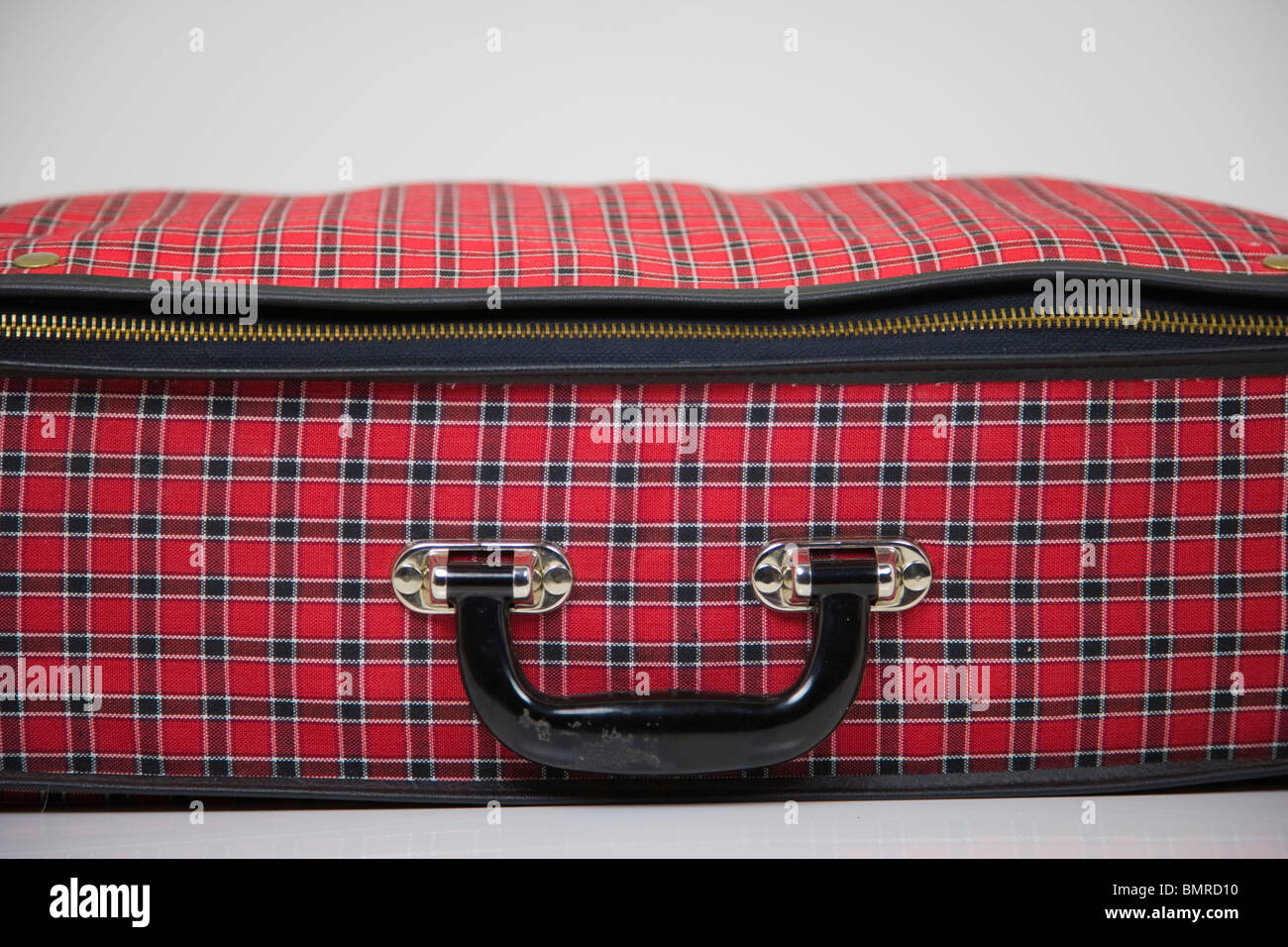 Red checked pattern suitcase on white background Stock Photo - Alamy