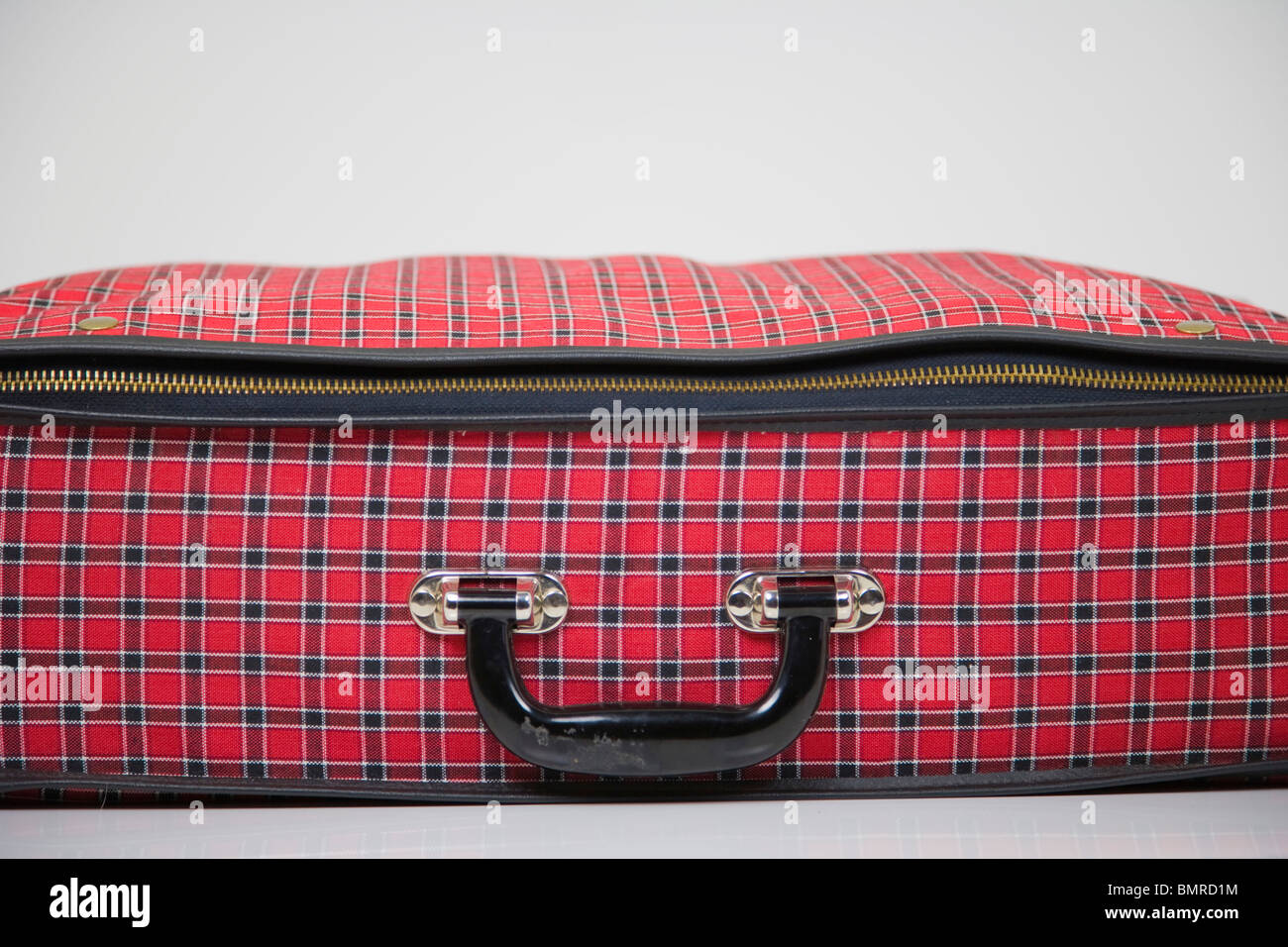 Red checked pattern suitcase on white background Stock Photo - Alamy