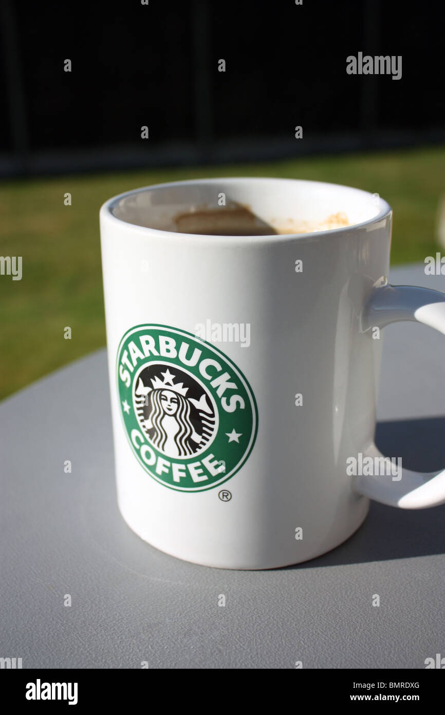 Enjoying a Starbucks coffee whilst reading the daily newspaper Stock ...