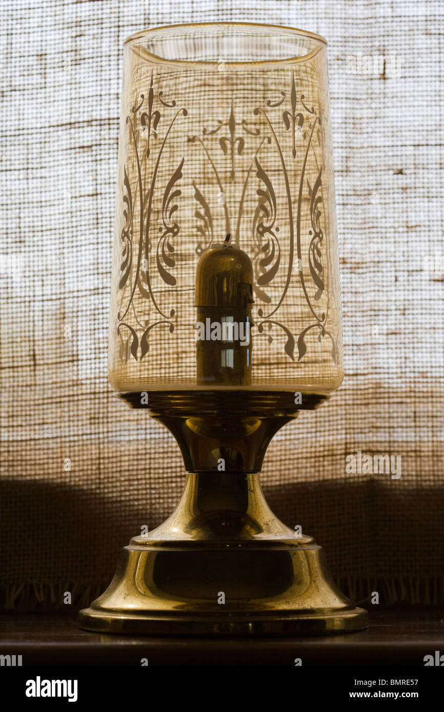 Old candle lamp on windowboard against Hessian covered window Stock ...