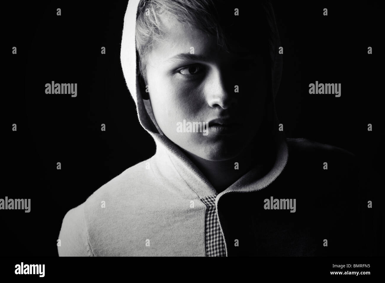 Shot of a Teenager in Hooded Top Looking Shady Stock Photo - Alamy