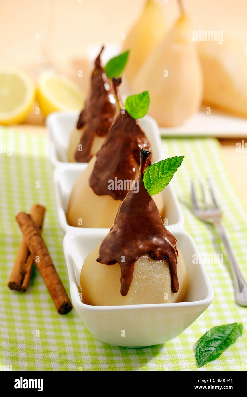 Poached pears with chocolate. Recipe available Stock Photo - Alamy