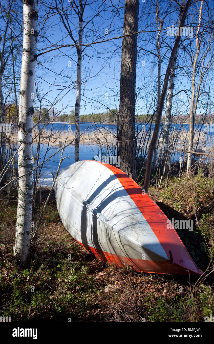 Aluminum rowboat / skiff / dinghy upside at lake shore , Finland Stock ...