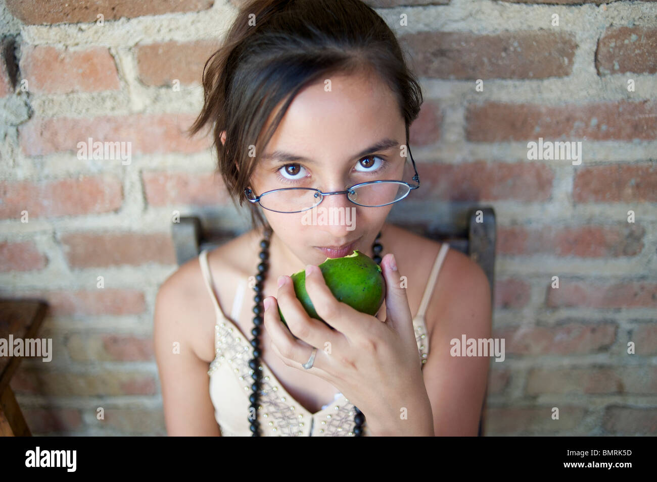 Cuban girl eating mango Stock Photo - Alamy