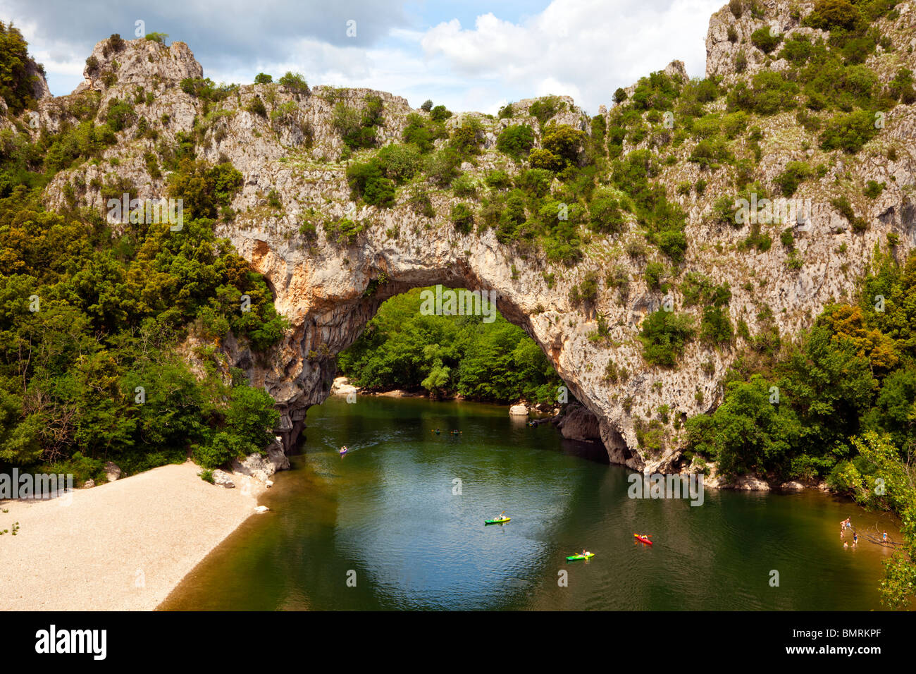canoeing below the natural stone arch Pont d'arc across the Ardèche ...