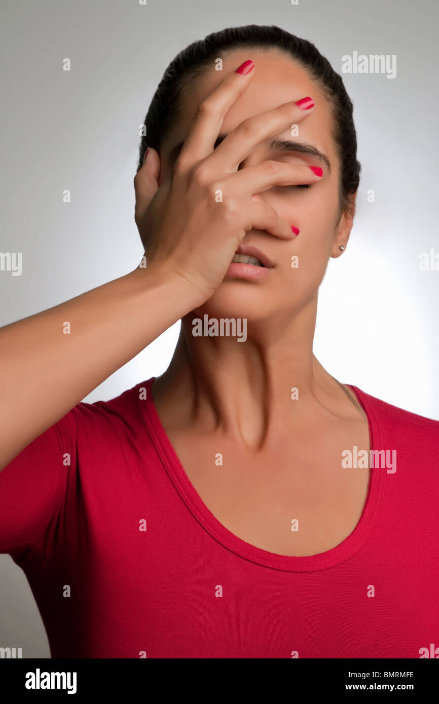 Woman covering face with hand Stock Photo - Alamy