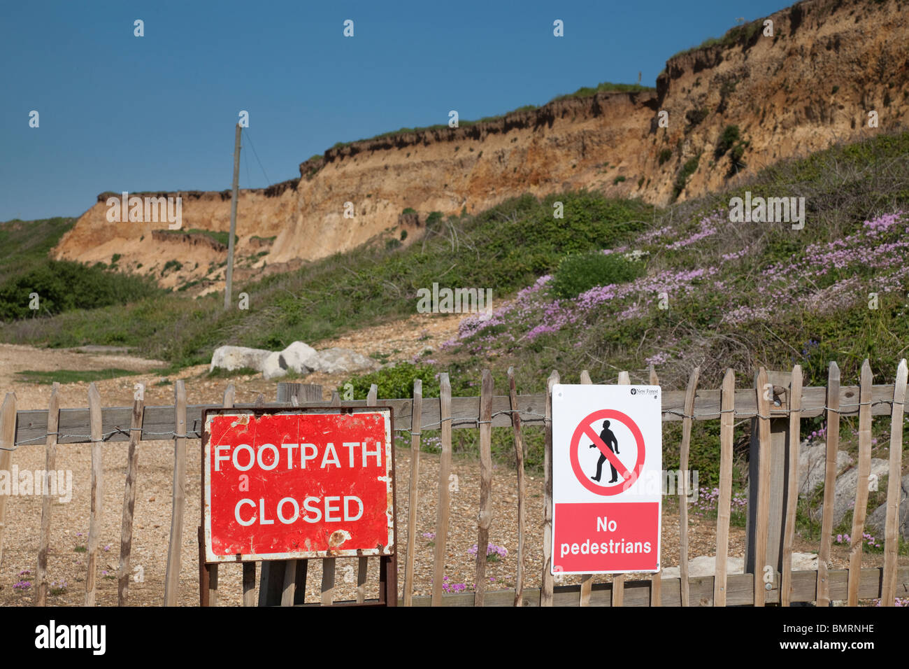 under cliff path closed sign and fencing due to ground movement erosion ...
