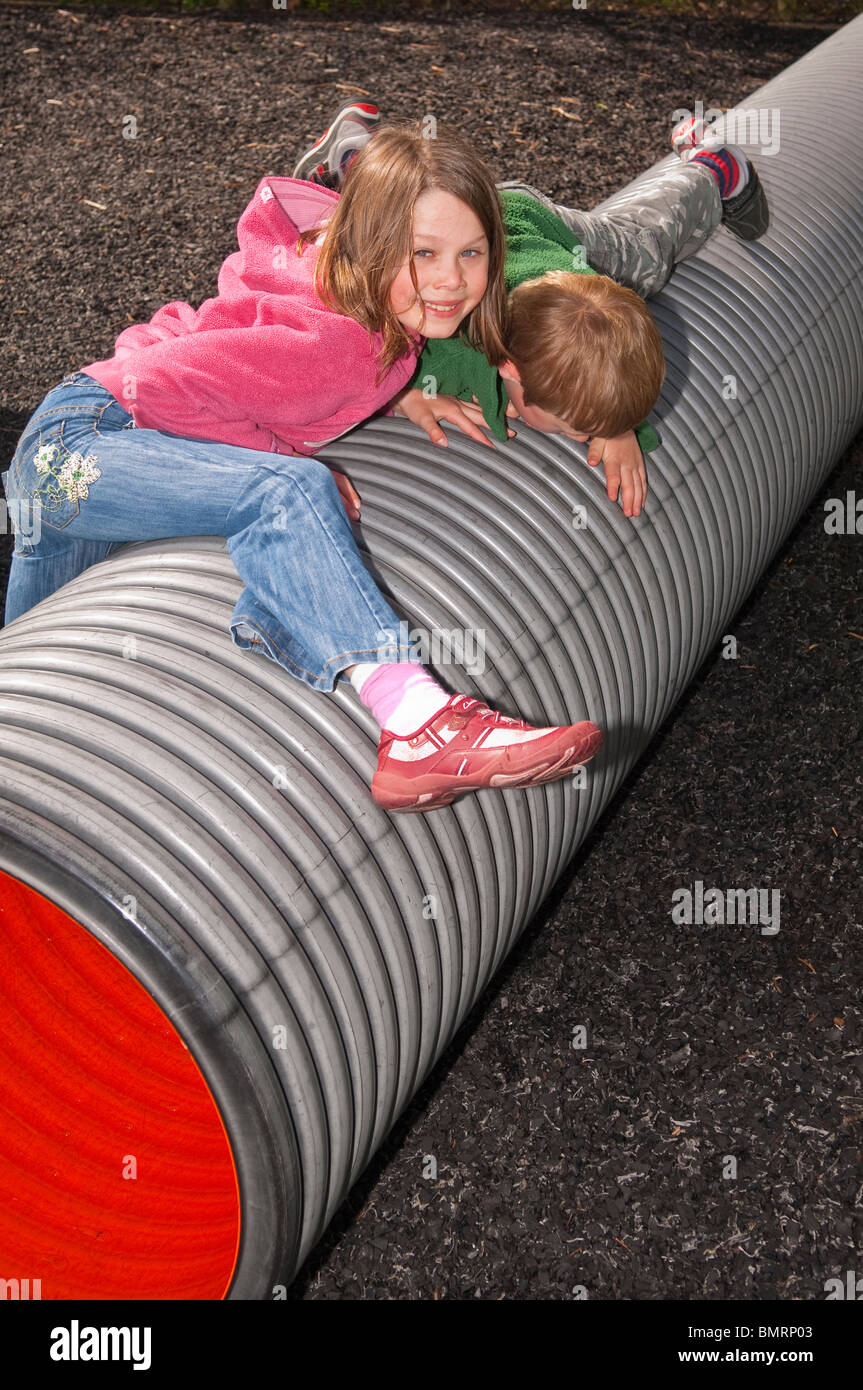 A MODEL RELEASED picture of a girl and boy ( 8 & 6 ) on outdoor play ...