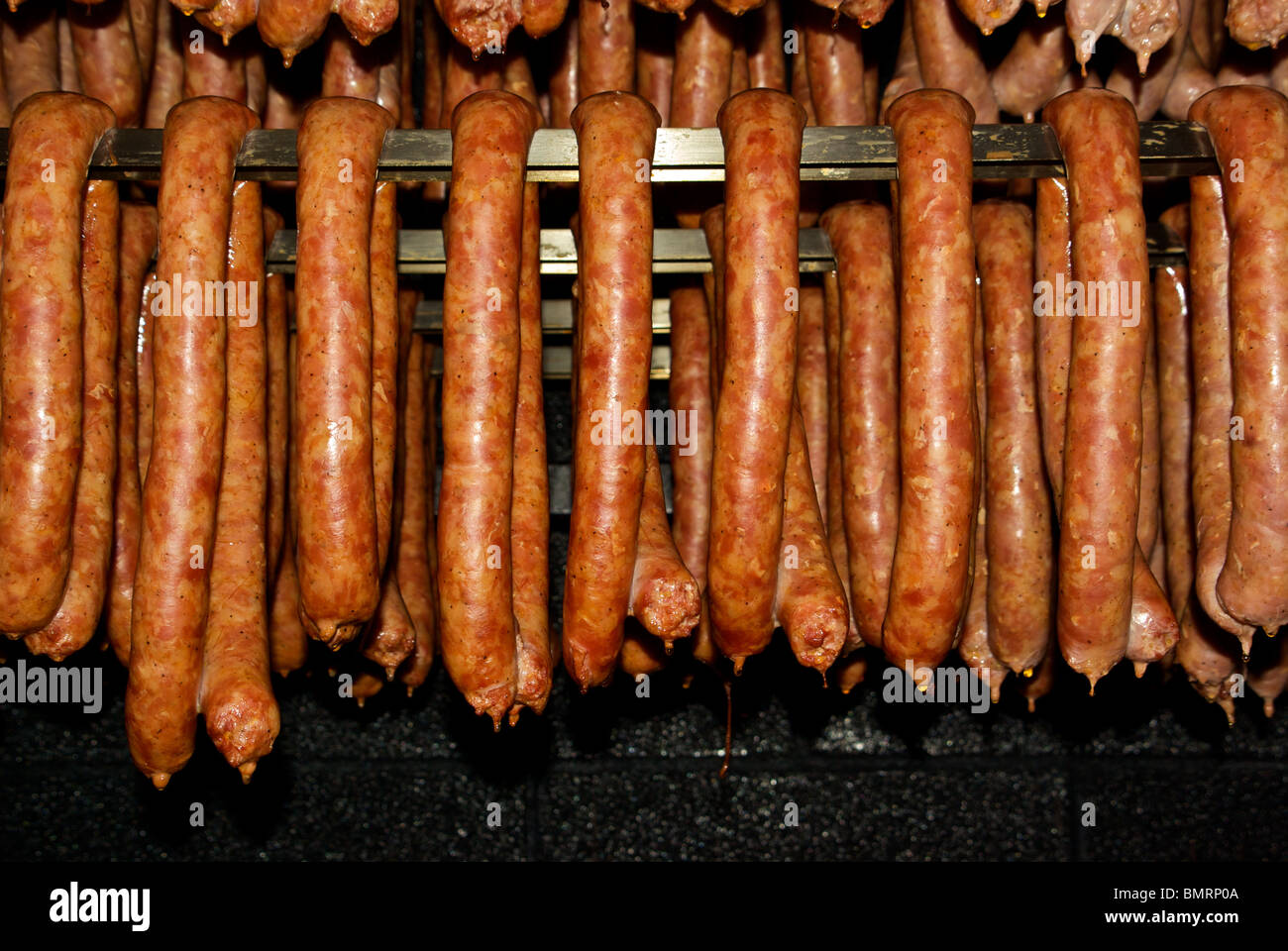 Racks of smoked pork sausages in smokehouse at Johnson's Boucaniere ...