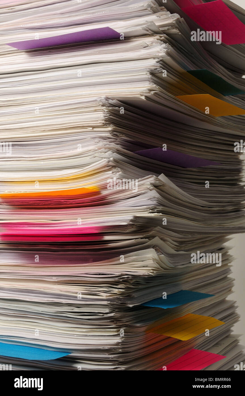 A stack of used sheets of white paper with colored paper markers Stock ...