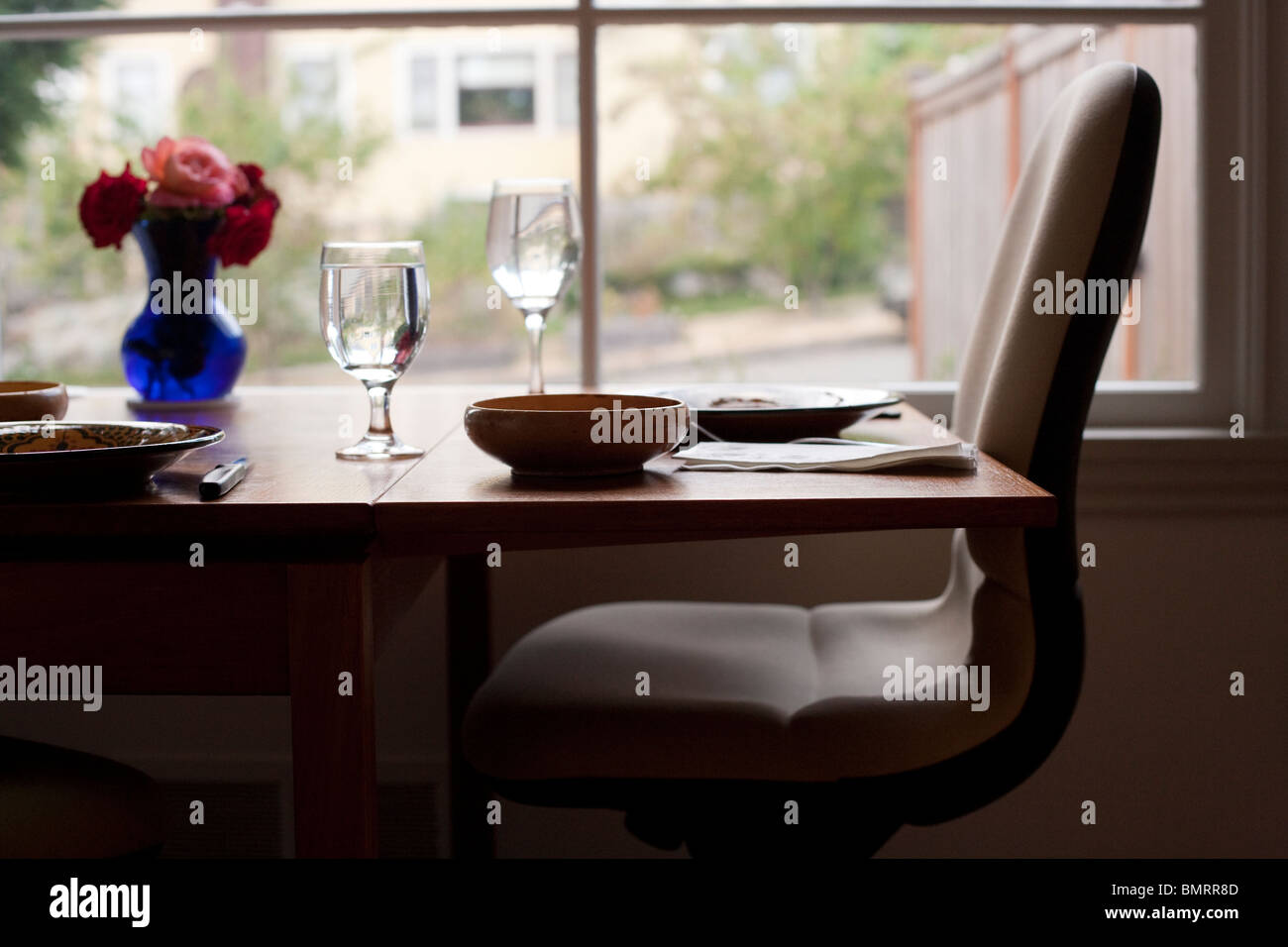 Close up of a table for two by a restaurant window Stock Photo - Alamy