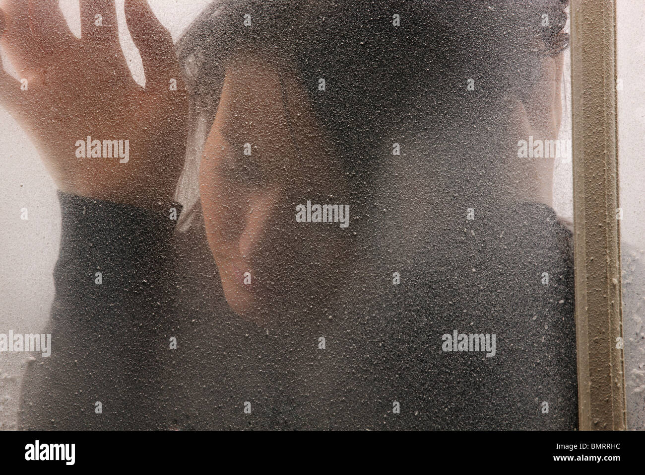A Woman Behind A Cold, Frosted Window Stock Photo - Alamy
