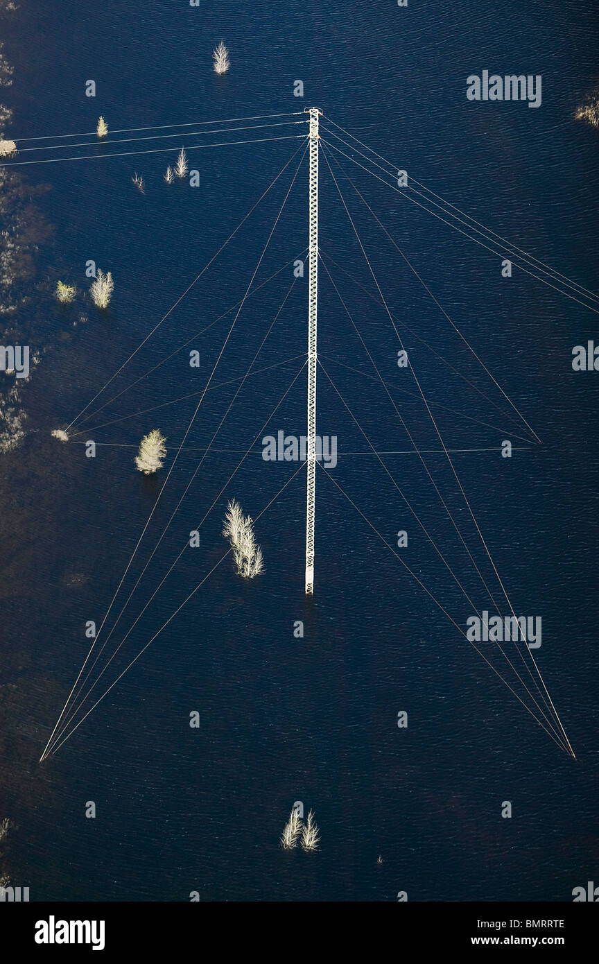 aerial view above radio mast radiator antenna tower anchored in water ...