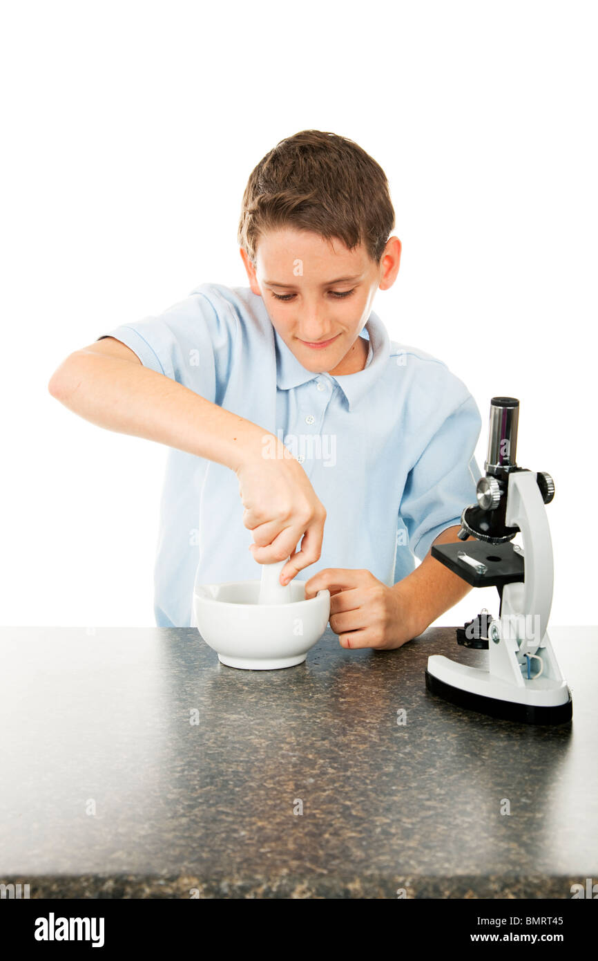 School boy in science class using a mortar and pestle. White background ...