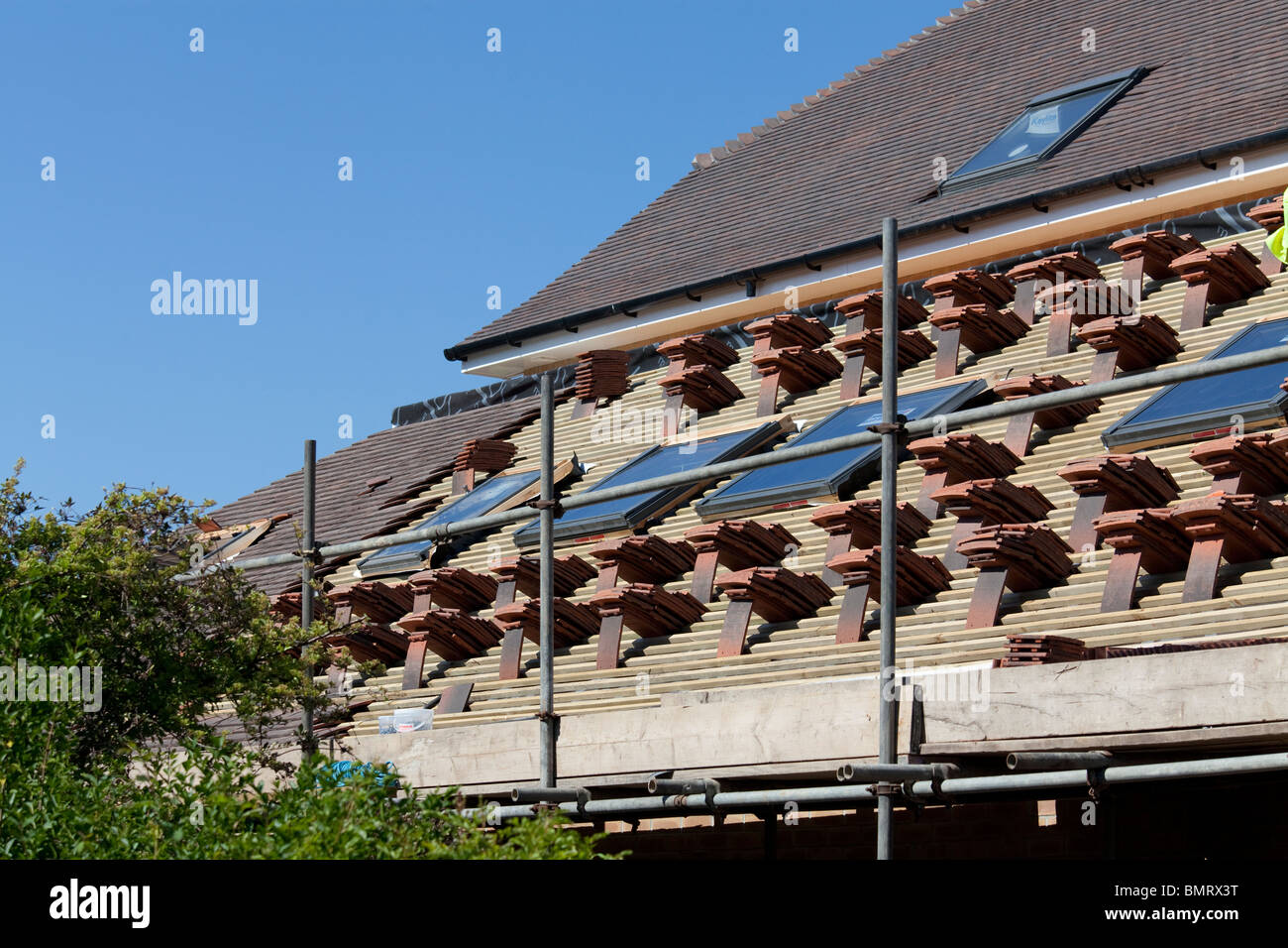 stacked roofing tiles ready fo tiling a new roof around roof windows ...