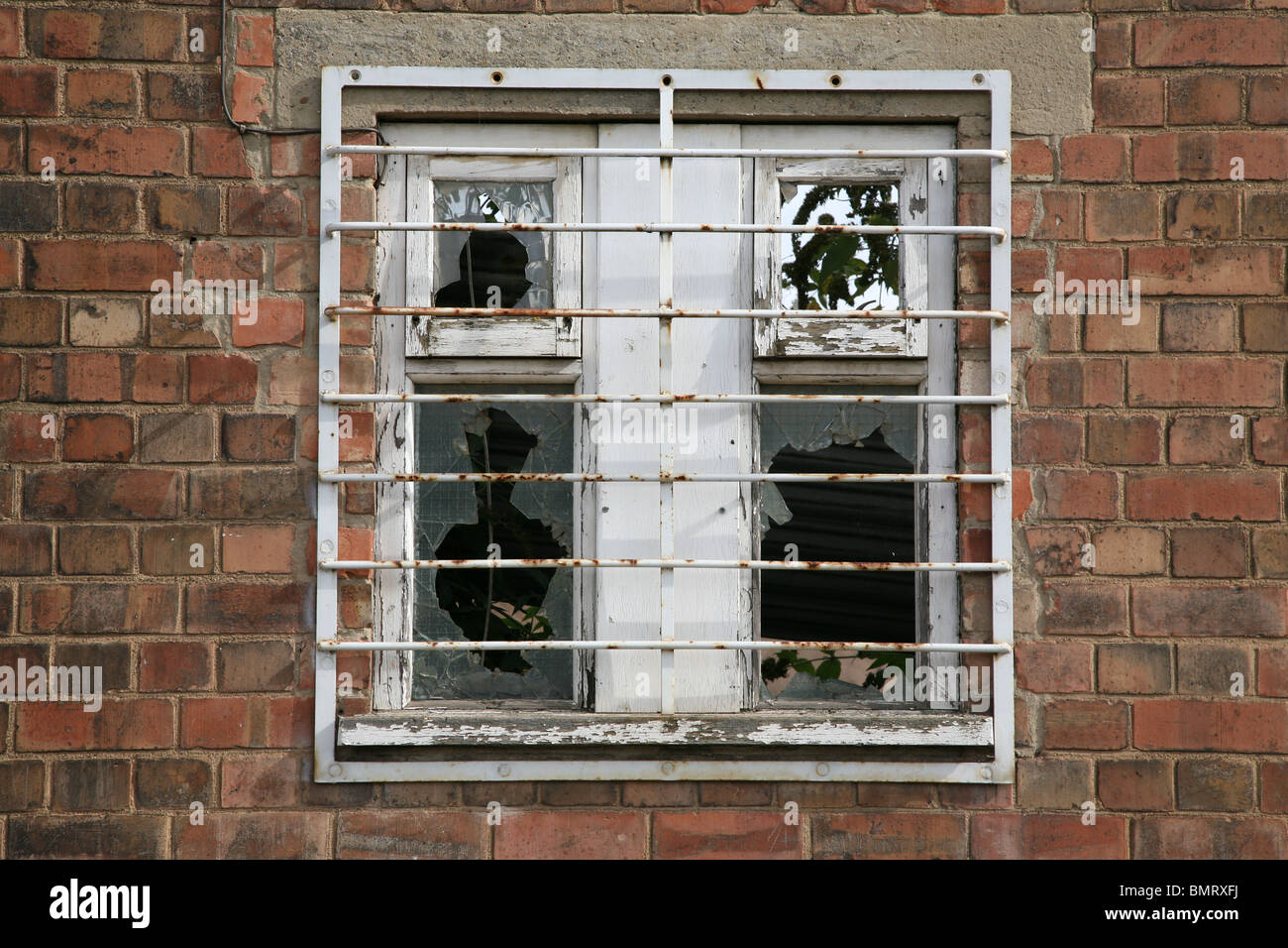 a smashed window on a soon to be demolished building Stock Photo - Alamy